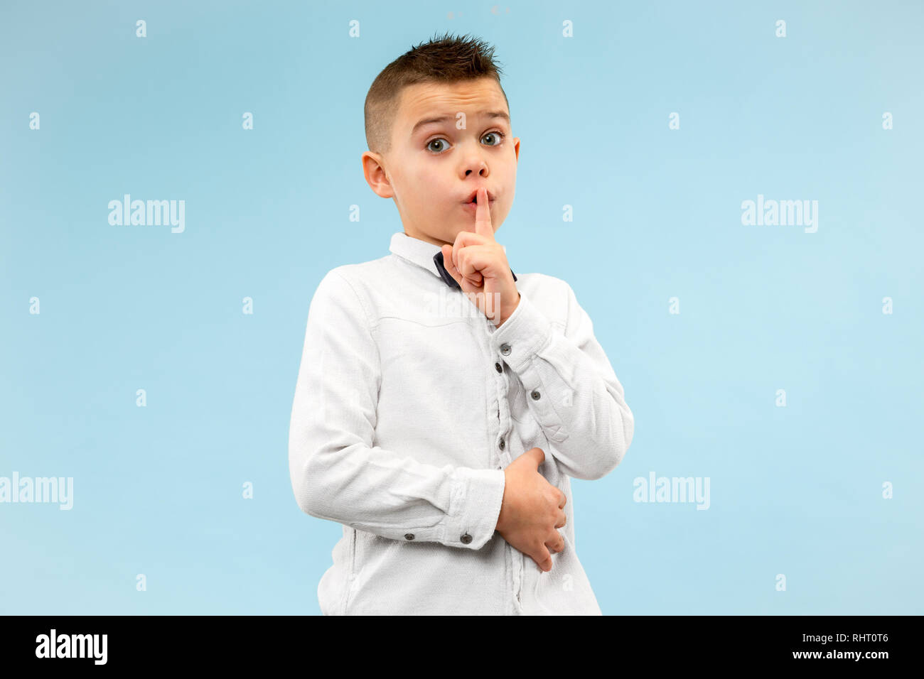 Secret, gossip concept. Teen boy whispering a secret behind his hand ...