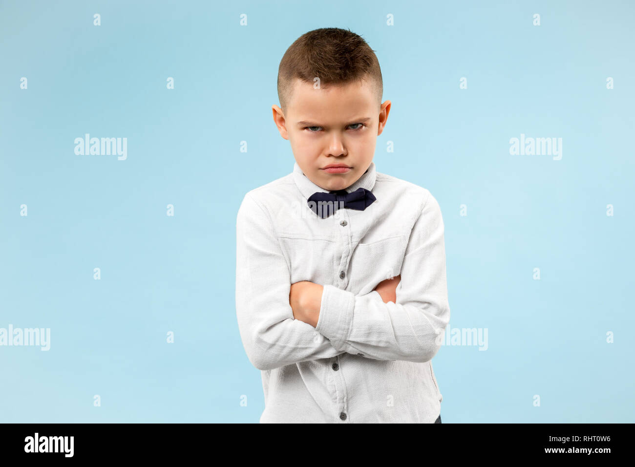 Screaming, hate, rage. Crying emotional angry teen boy on blue studio ...