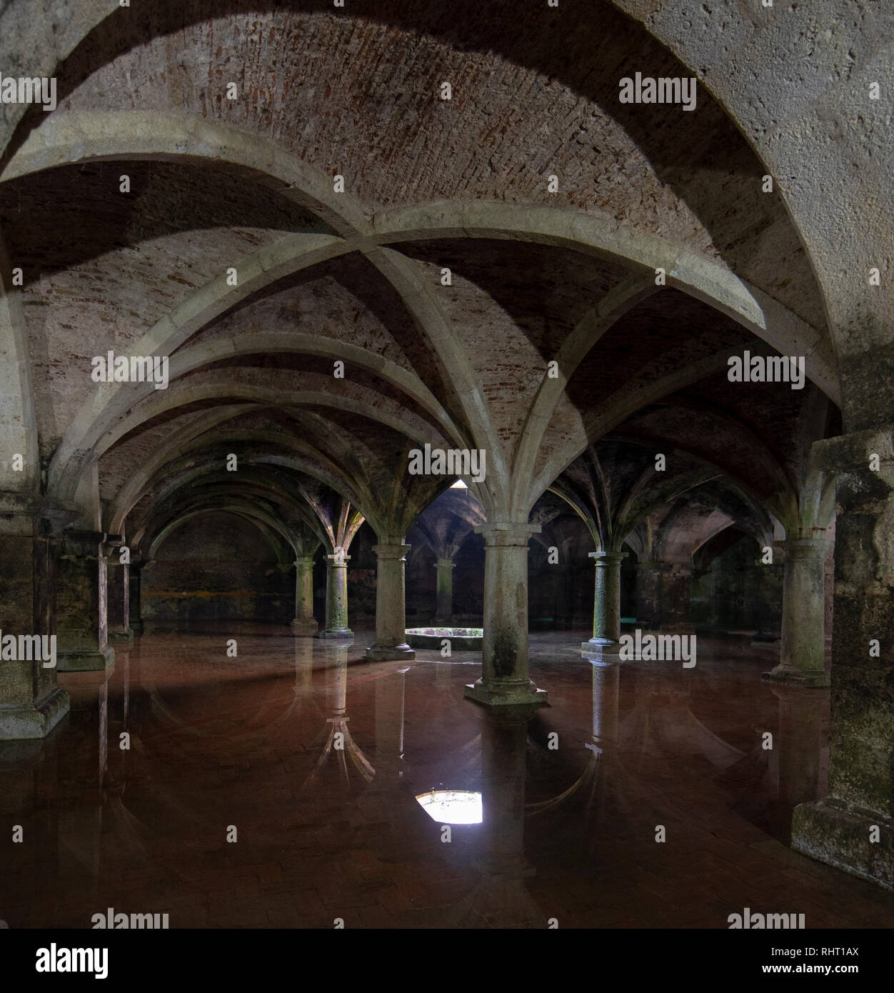 Inside interior of the old Manueline Cistern reflection. Sunlight beam ...