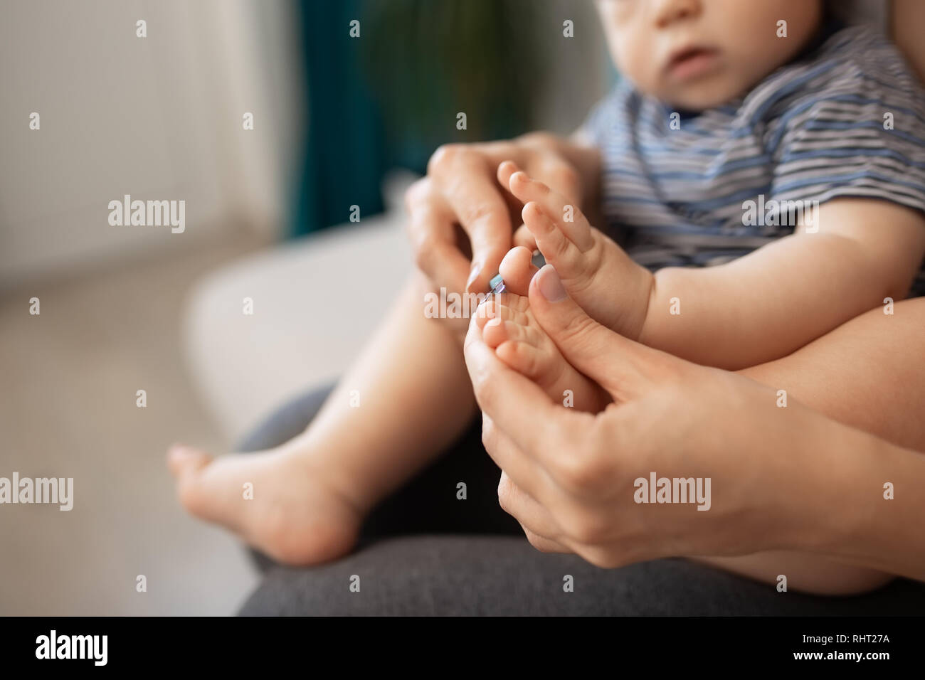 closeup mother cutting nails for baby using safety scissors Stock Photo ...