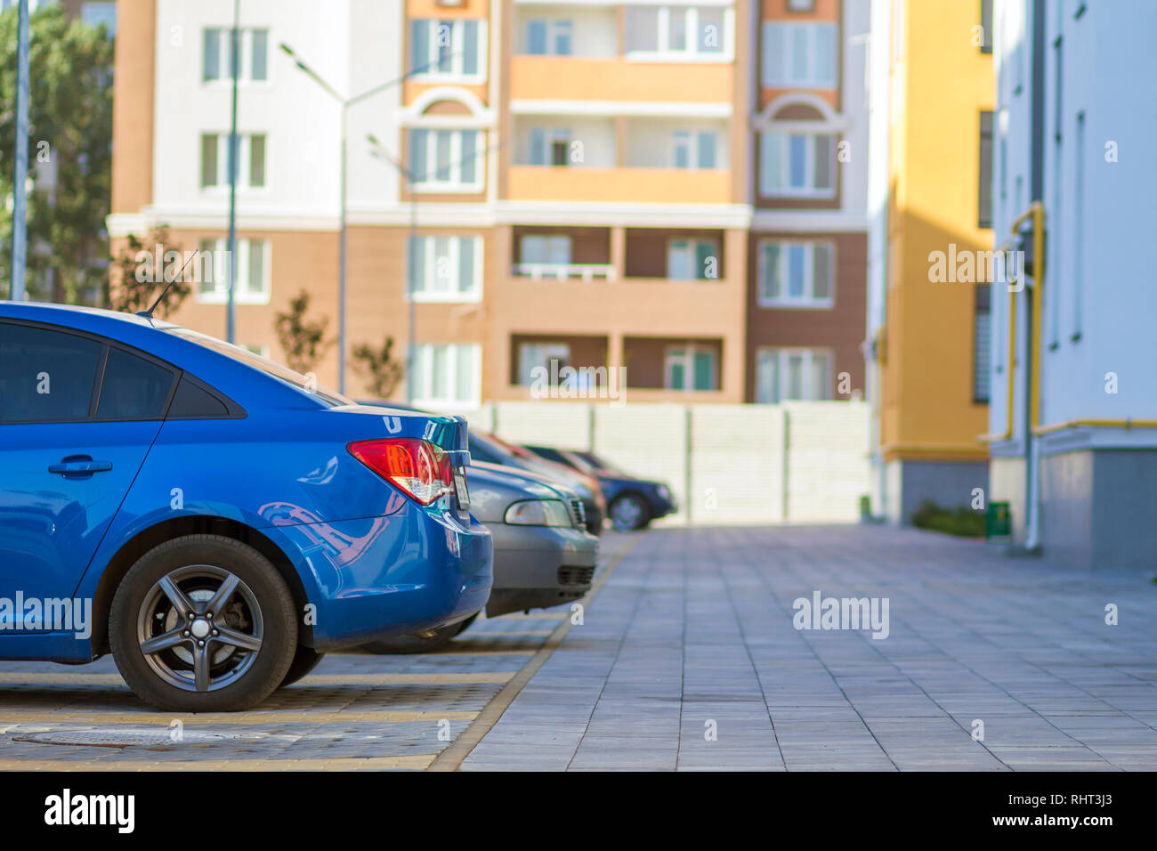 Side view detail of cars row parked in paved yard parking lot area on ...