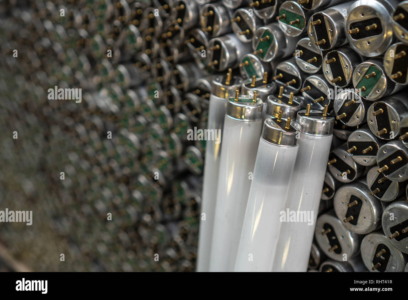 Old fluorescent lamps are stacked in rows. Background view Stock Photo ...