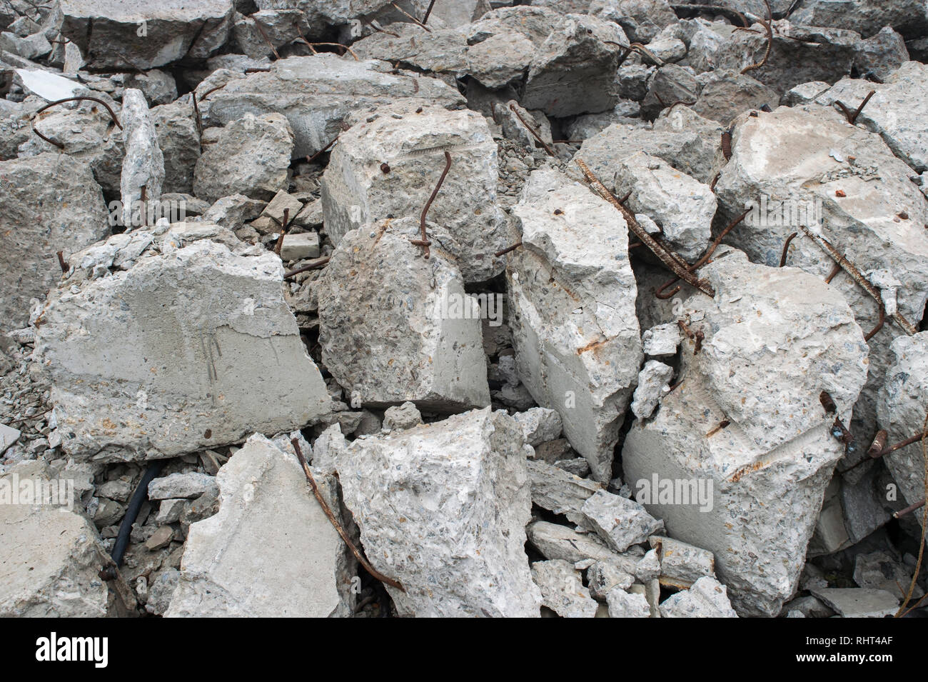 Fragments of concrete slabs in the form of large gray stones with ...