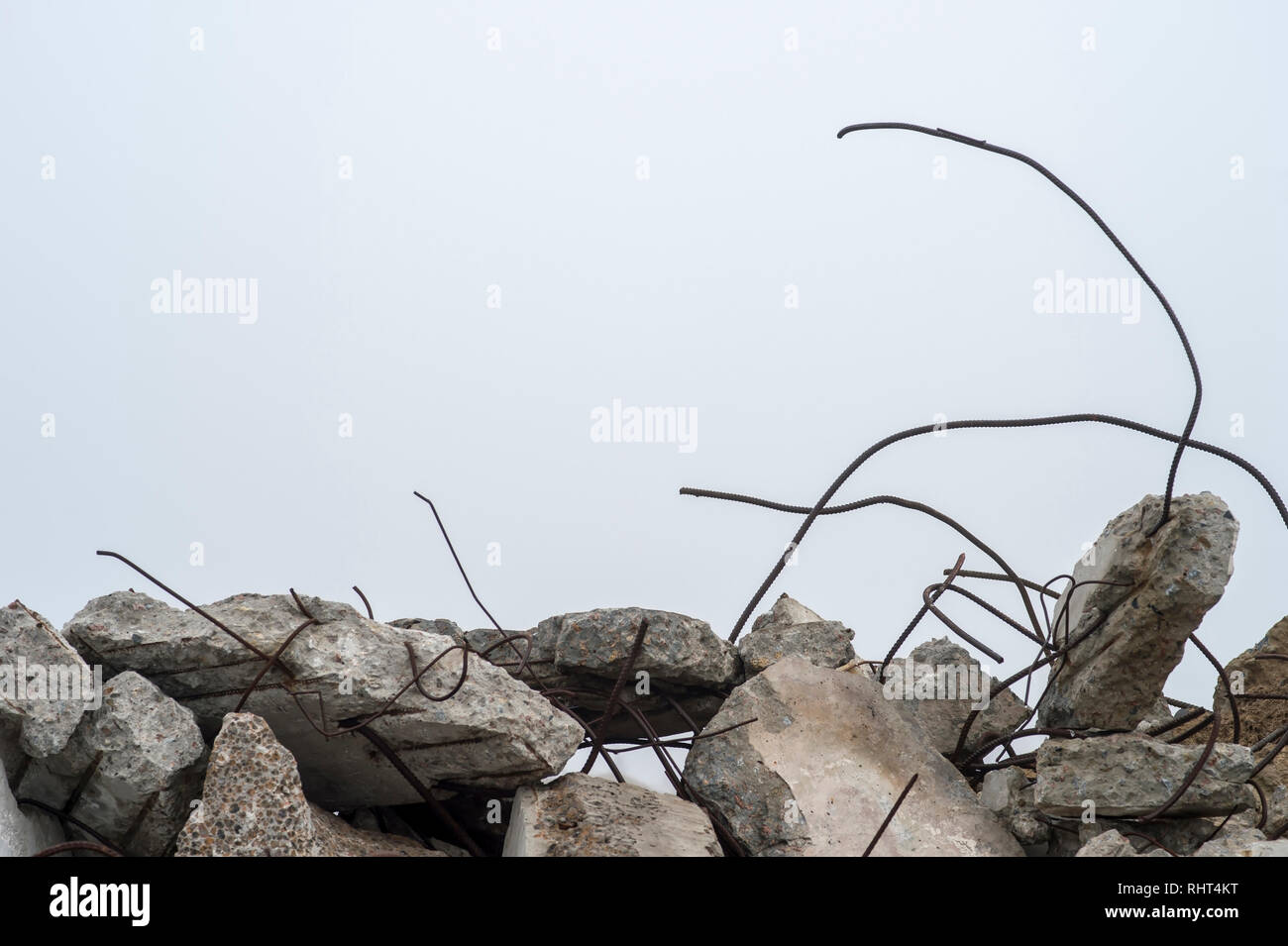The rebar sticking up from piles of brick rubble, stone and concrete ...