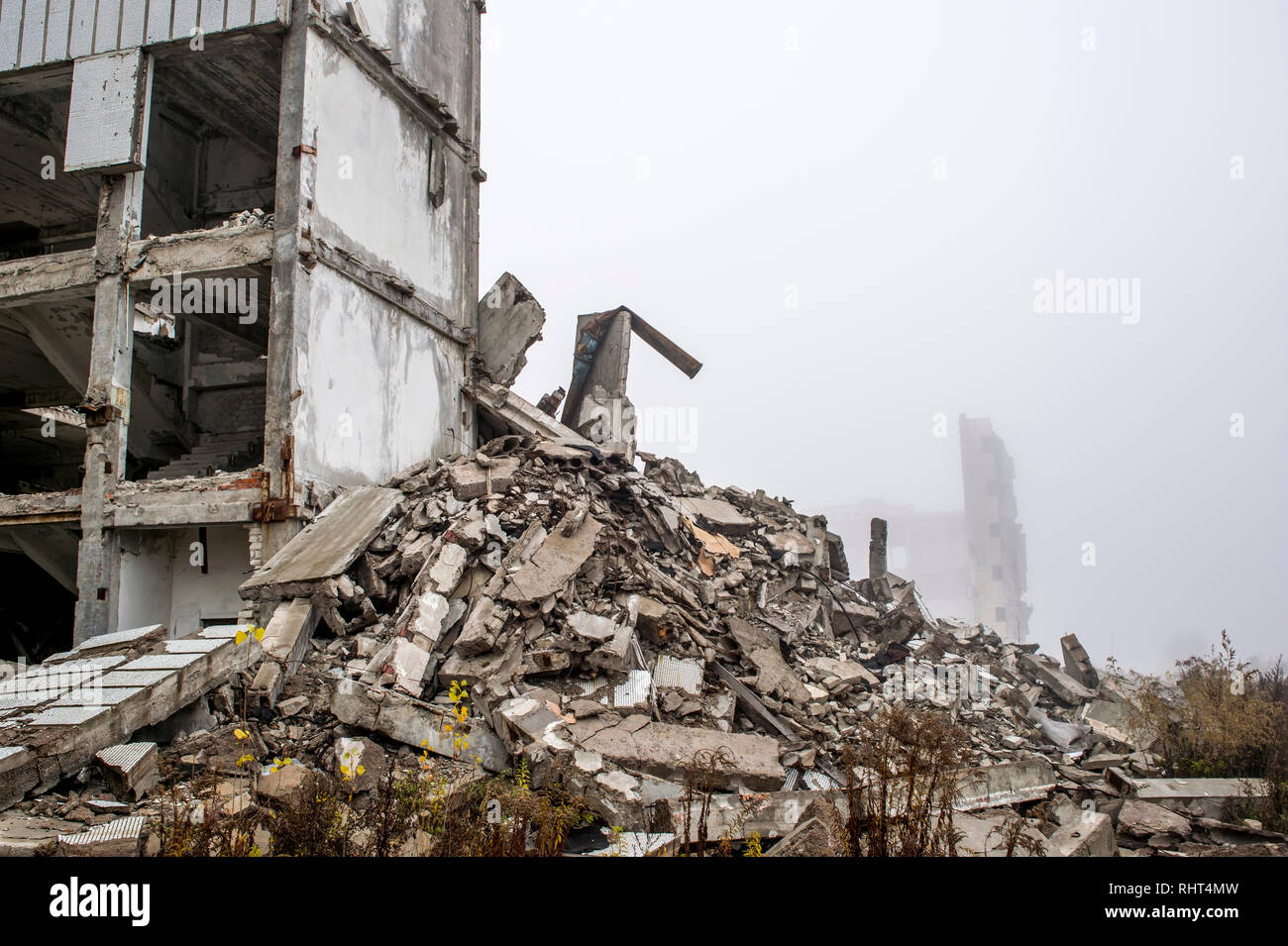 A huge pile of gray concrete debris from piles and stones of the ...