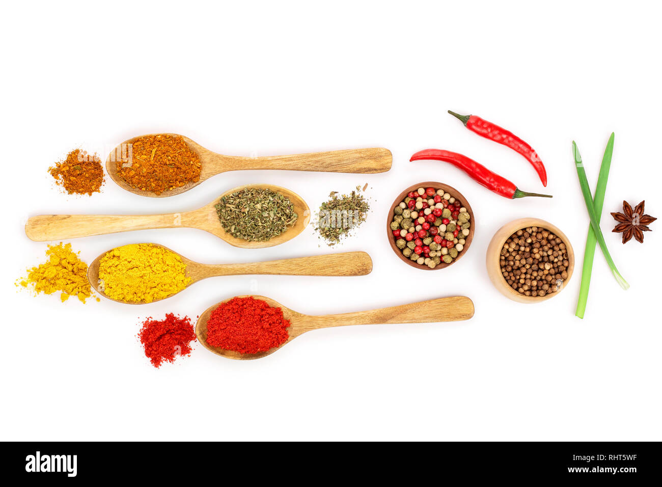 mix of spices in wooden spoon isolated on a white background with copy ...