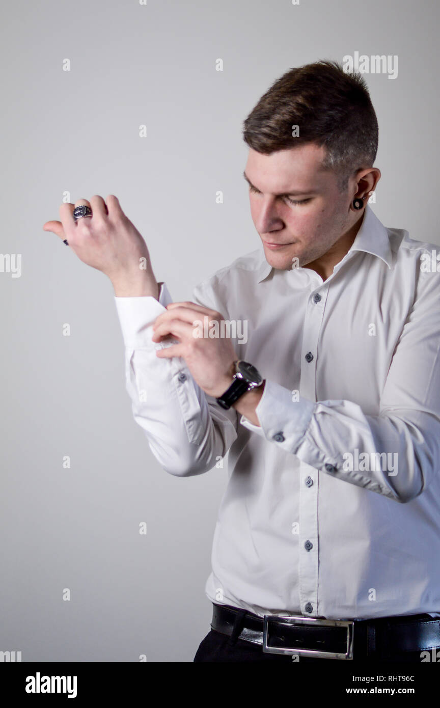 Adjusting shirt hi-res stock photography and images - Alamy