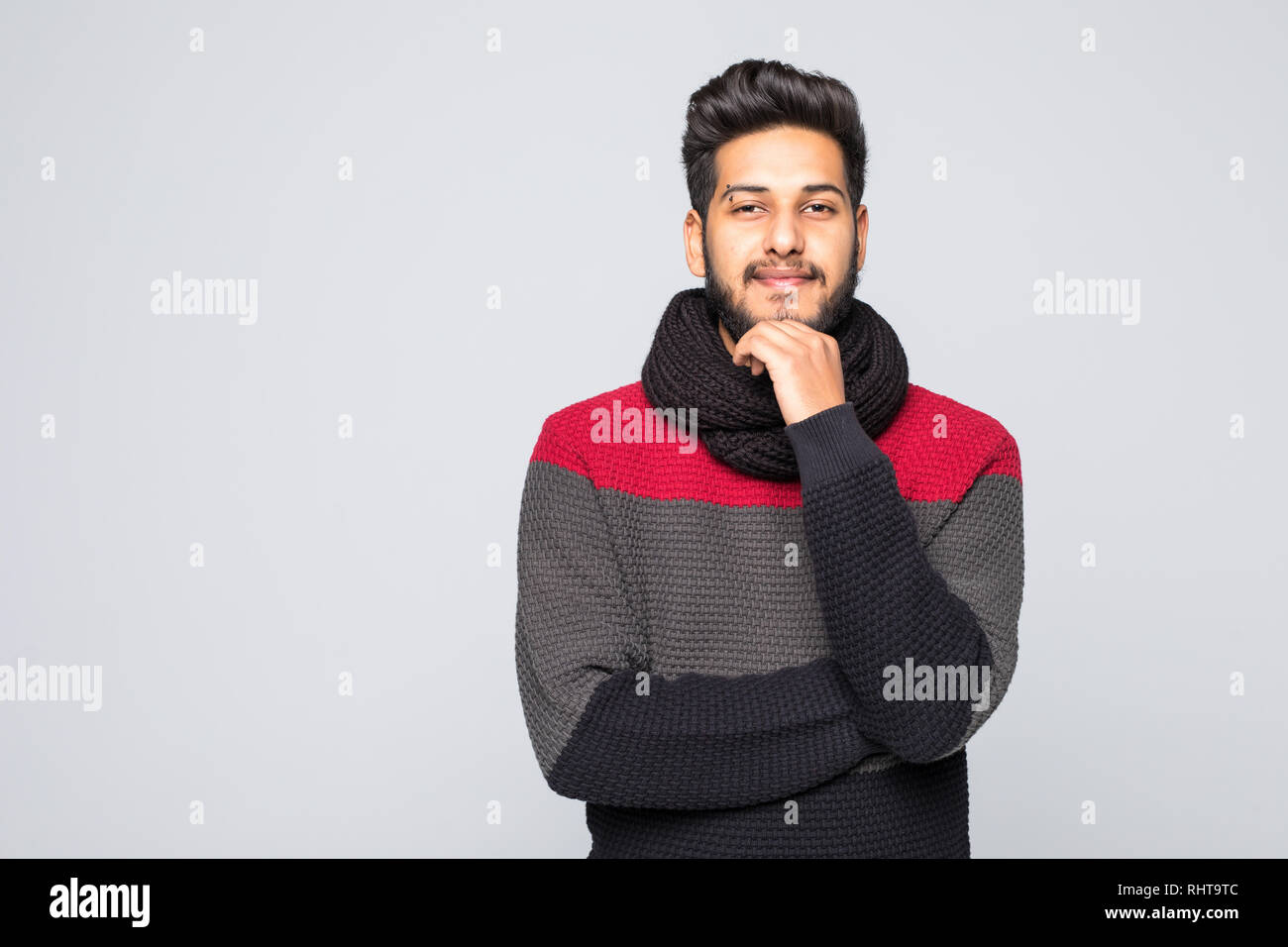 Handsome arabic man wearing winter sweater over isolated gray ...