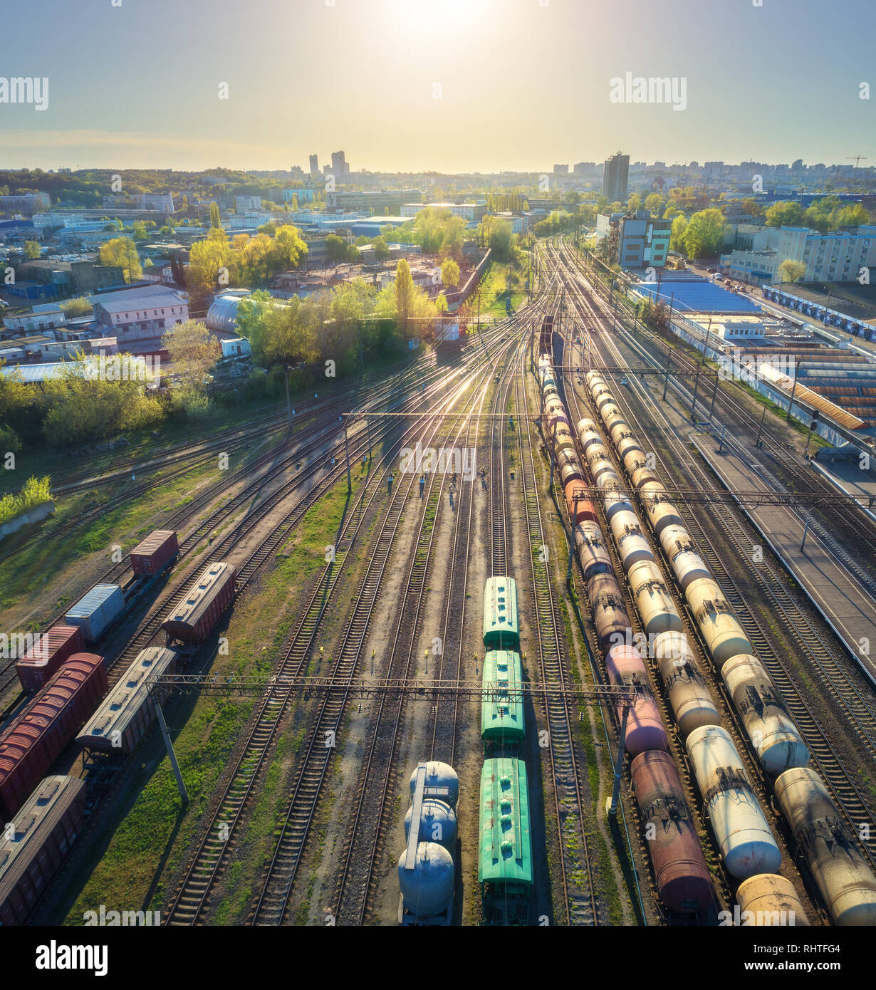 Aerial view of colorful freight trains on railway station at sunset ...