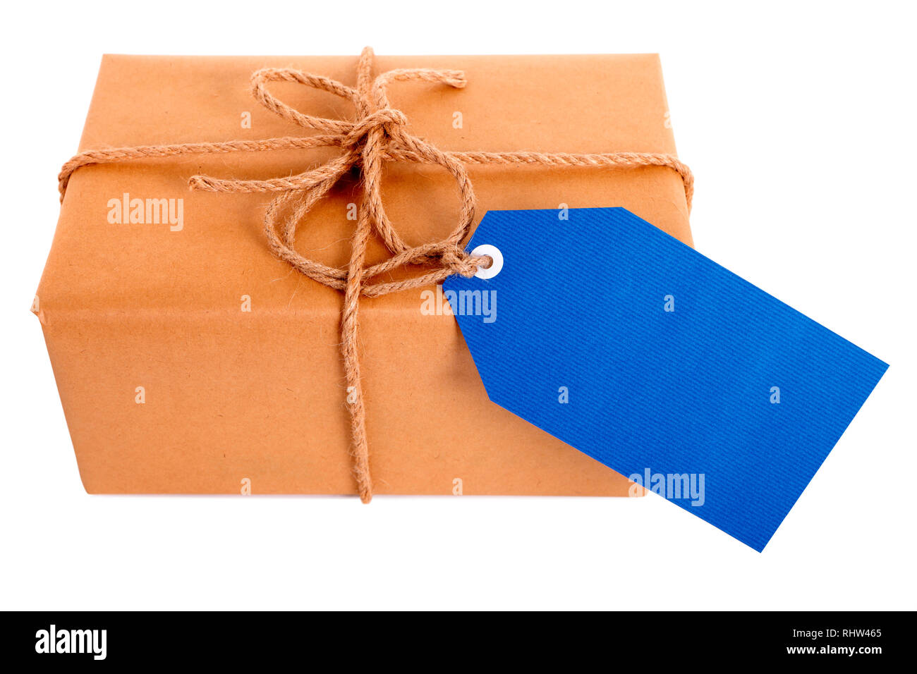 Plain brown paper package or parcel, blue gift tag or label and ribbon ...