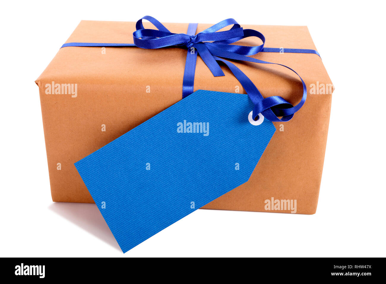 Plain brown paper package or parcel, blue gift tag or label and ribbon ...