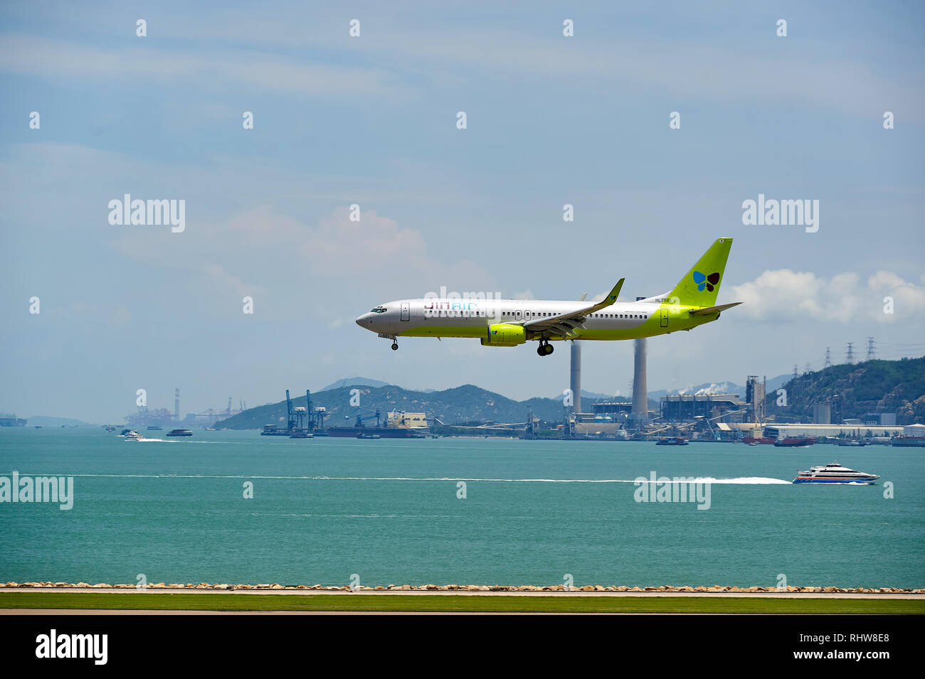HONG KONG - JUNE 04, 2015: Jin Air aircraft landing at Hong Kong ...
