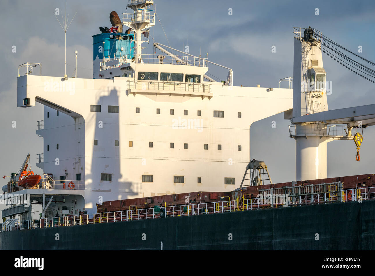 A picture of a cargo ship coming into harbour Stock Photo - Alamy