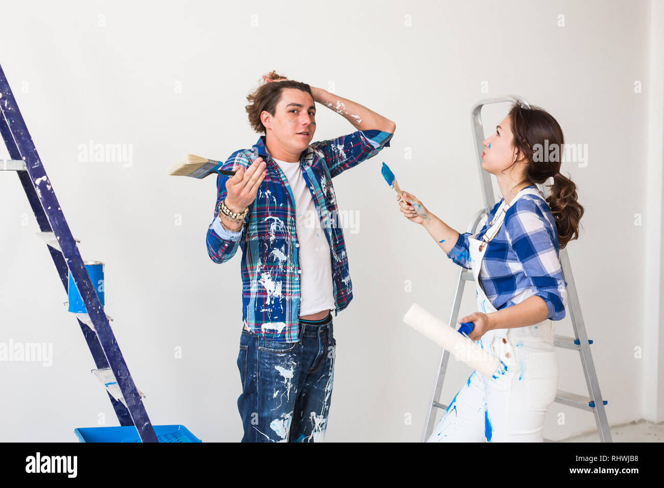 Conflict, redecoration and renovation concept - Young woman and man ...