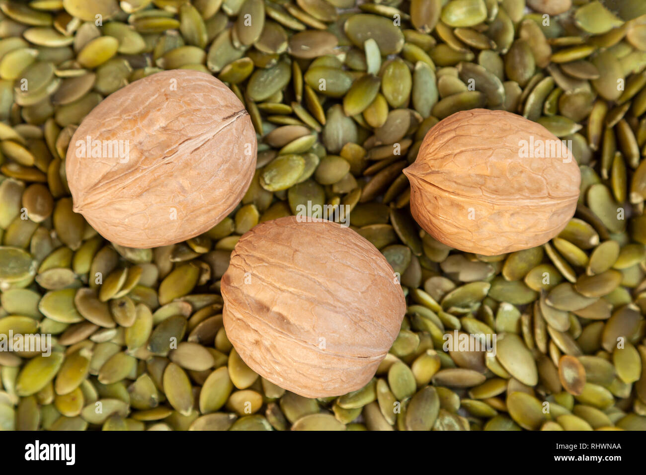 inshell walnut in the shell on pumpkin seeds Stock Photo - Alamy