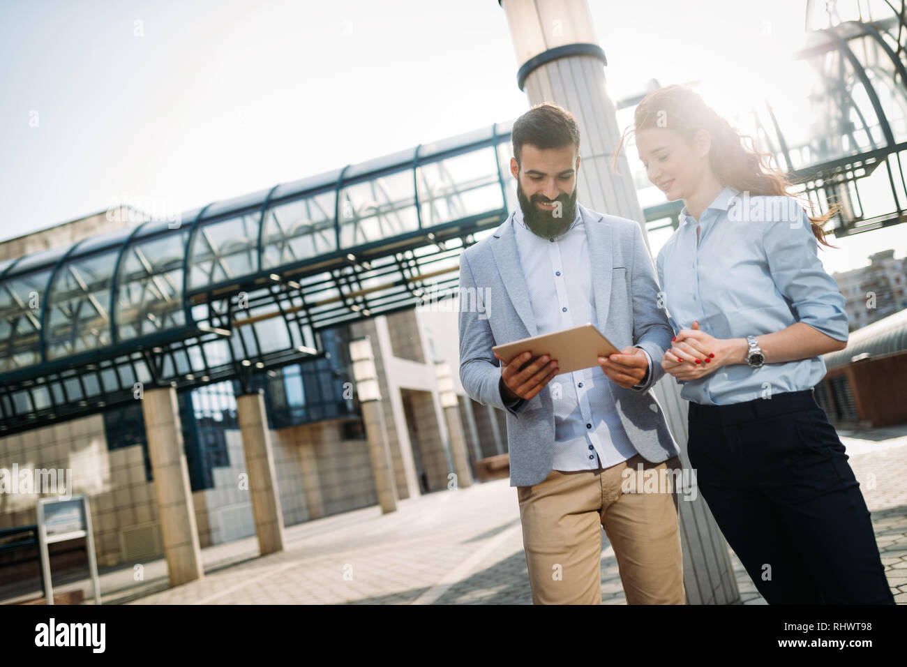 Picture of young attractive business partners standing Stock Photo - Alamy