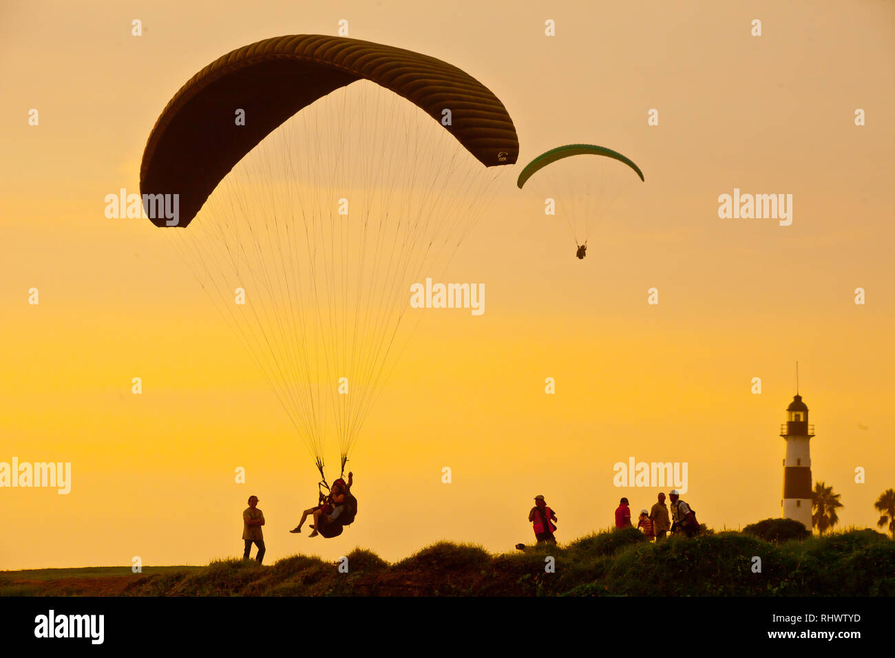 Parasuit ride in the sunset at Lima,Peru Stock Photo - Alamy