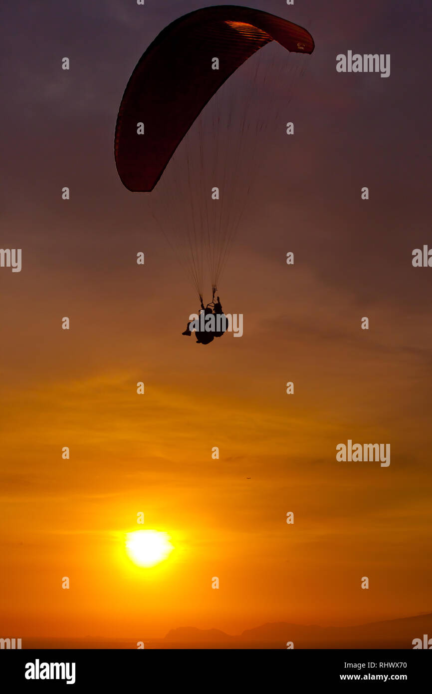 Parasuit ride in the sunset at Lima,Peru Stock Photo - Alamy