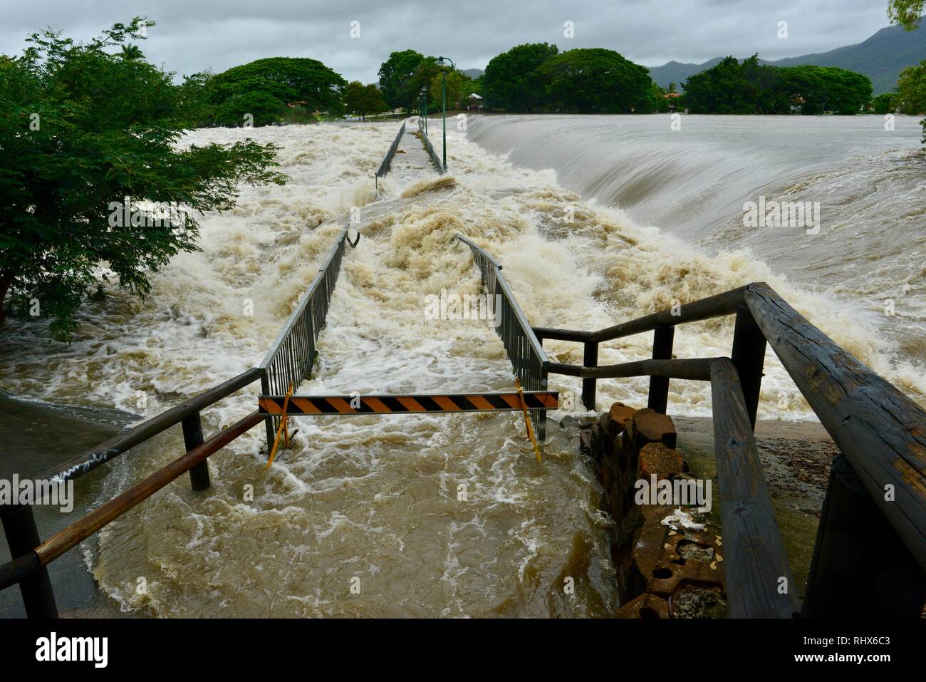 The raging flood waters inundating Aplins weir, Townsville, Queensland ...