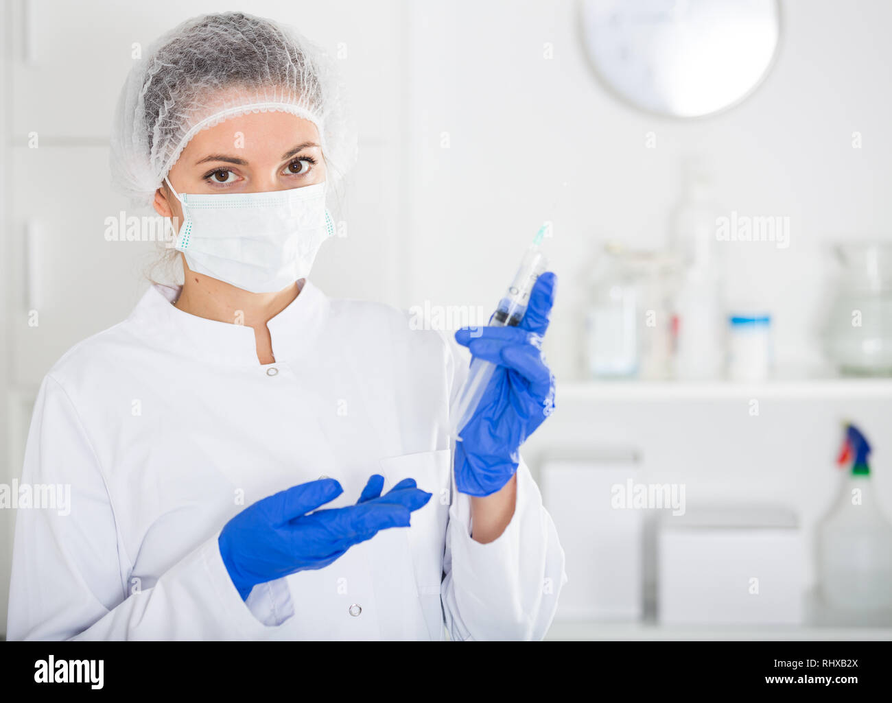 Female nurse holding syringe for injection in hospital Stock Photo - Alamy