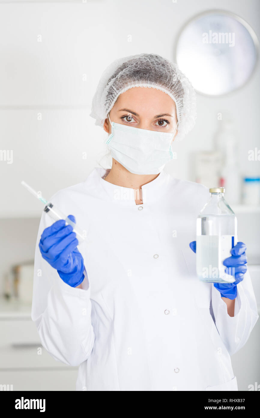 Professional nurse woman making injection in hospital Stock Photo - Alamy
