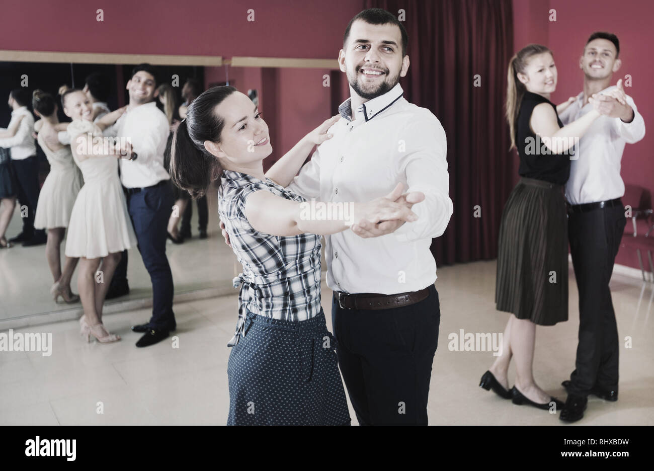 Smiling people learning to dance waltz in dancing class Stock Photo - Alamy