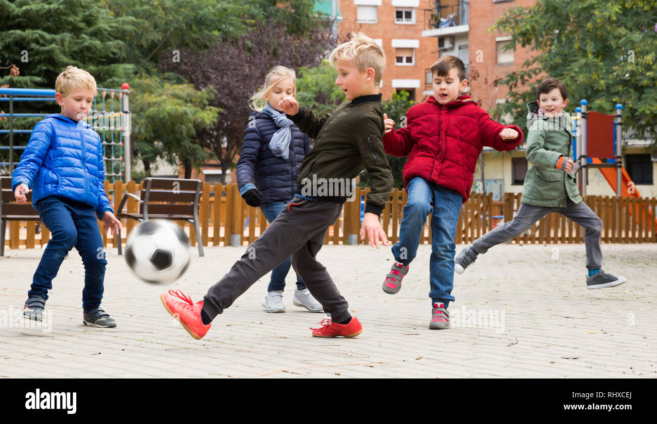 Group of laughing children playing football Stock Photo - Alamy