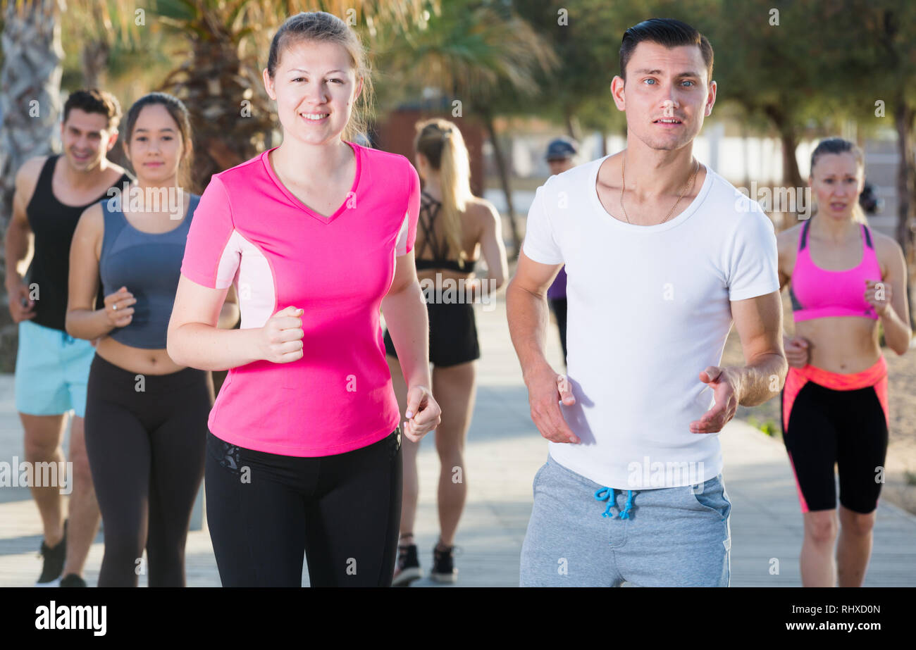 Active smiling people during running training in daytime Stock Photo ...