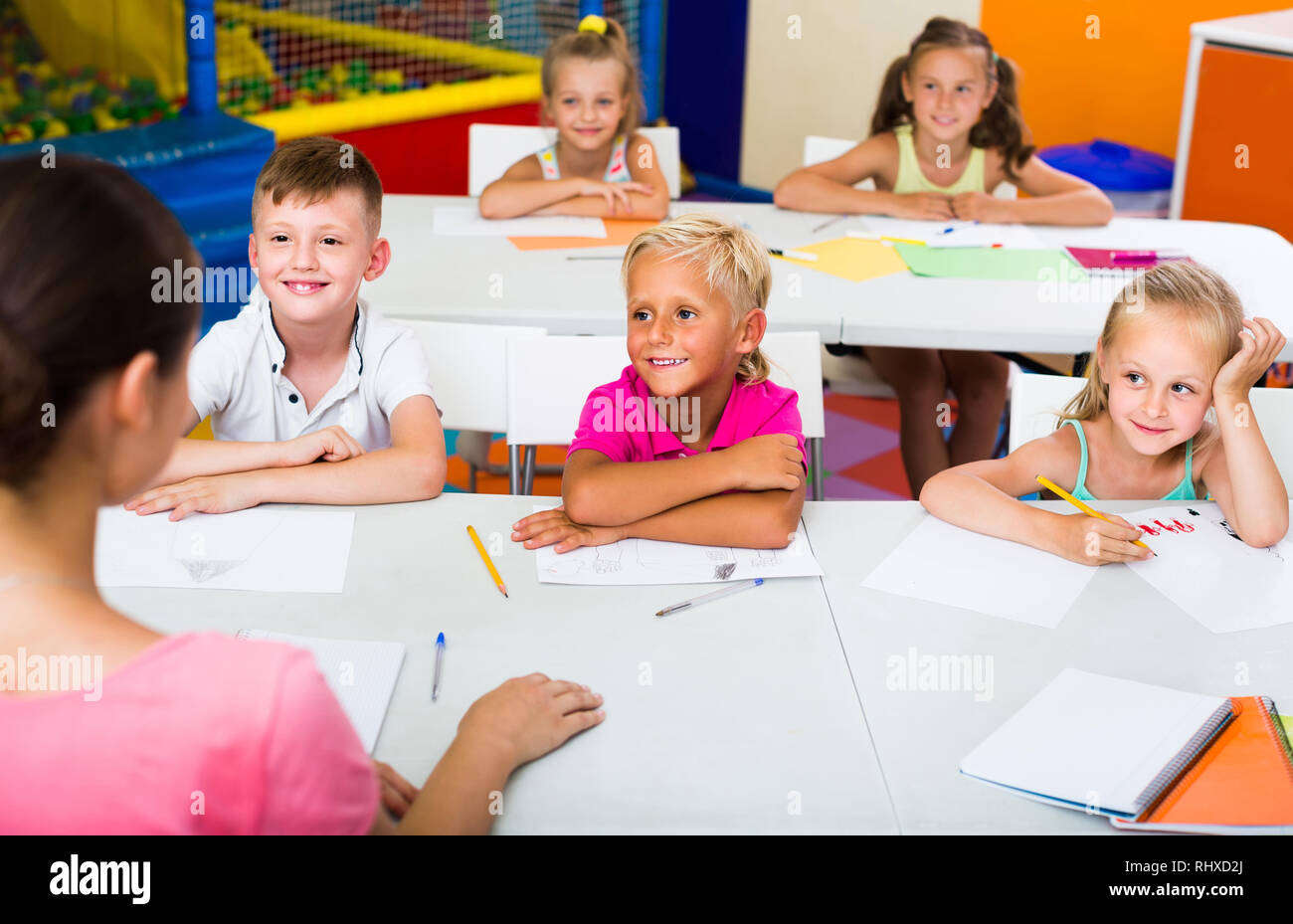 smiling russian children sitting together and studying in class at ...