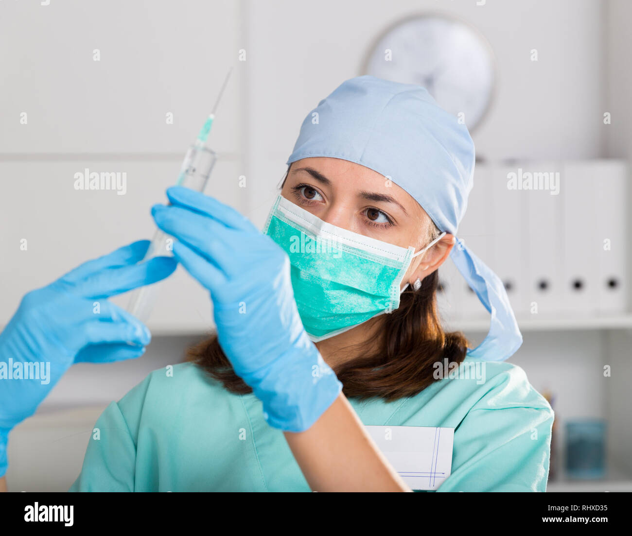 Professional nurse young woman making injection in modern hospital ...