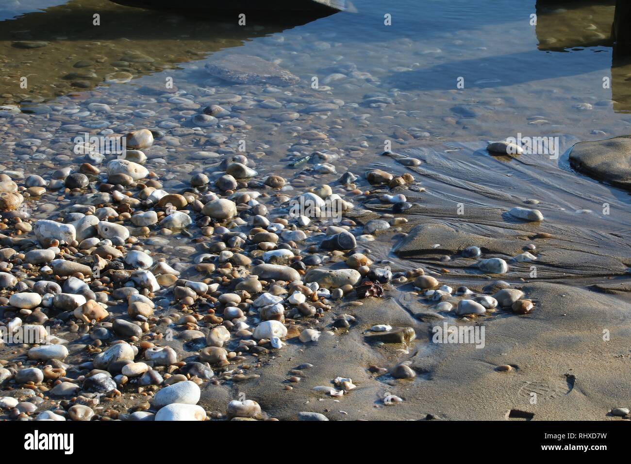 pebbles and sand in a clear sea water pool on beach Stock Photo - Alamy
