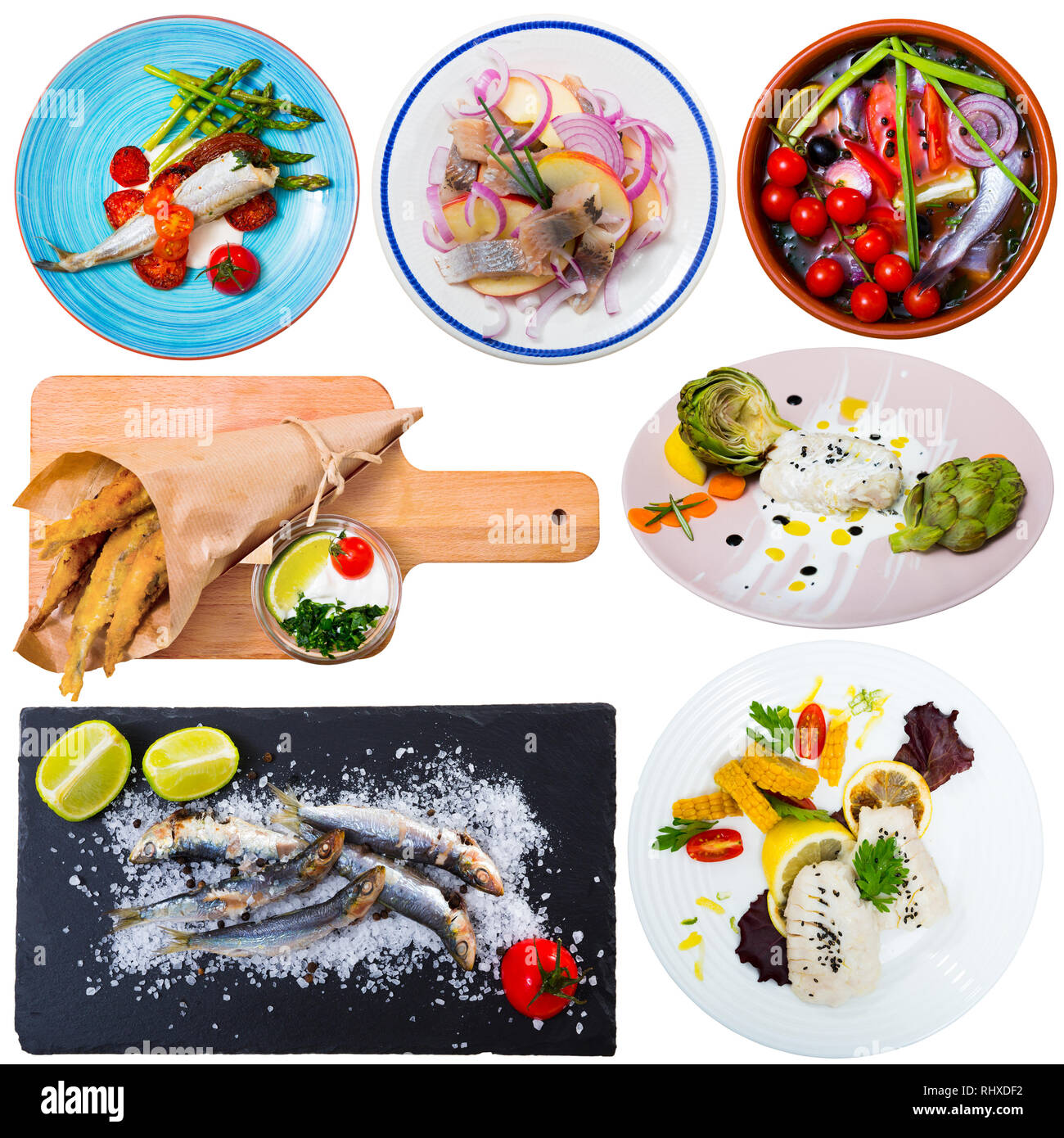 Set of various fish dishes served on plates, bowls and slates on white ...