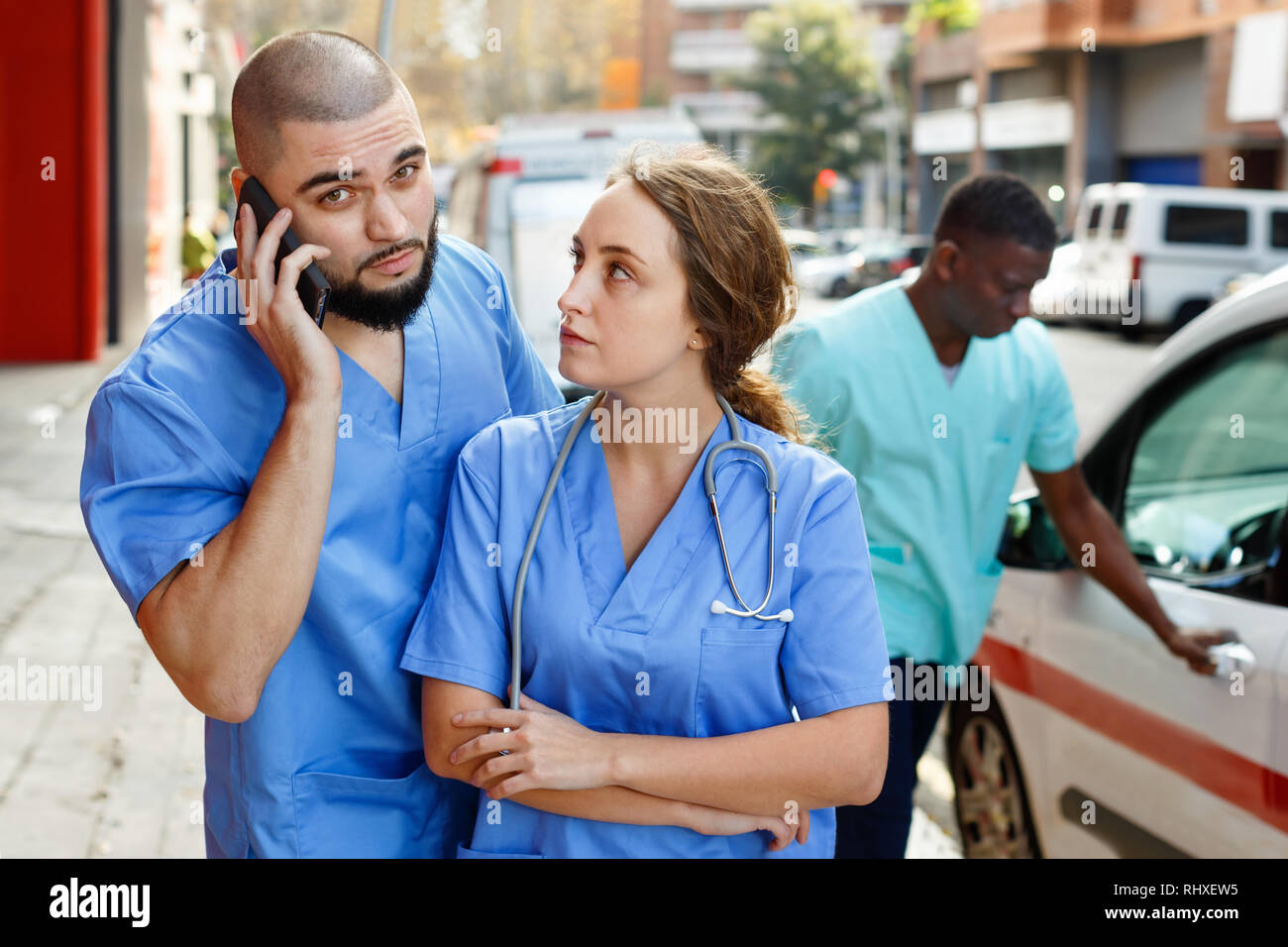 Positive smiling efficient paramedics with first aid kit going to call ...
