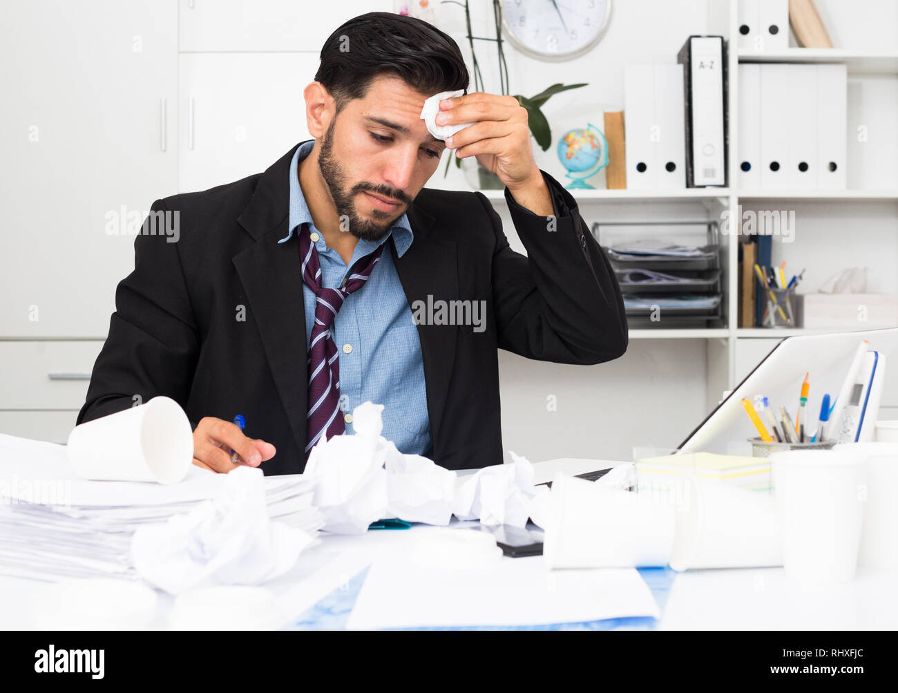 Spanish male worker is having complicated issue with project in office ...