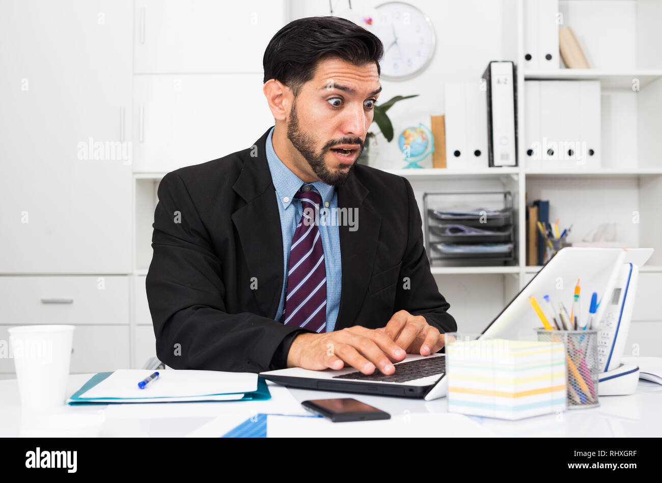 Spanish male worker is having complicated issue with project in office ...