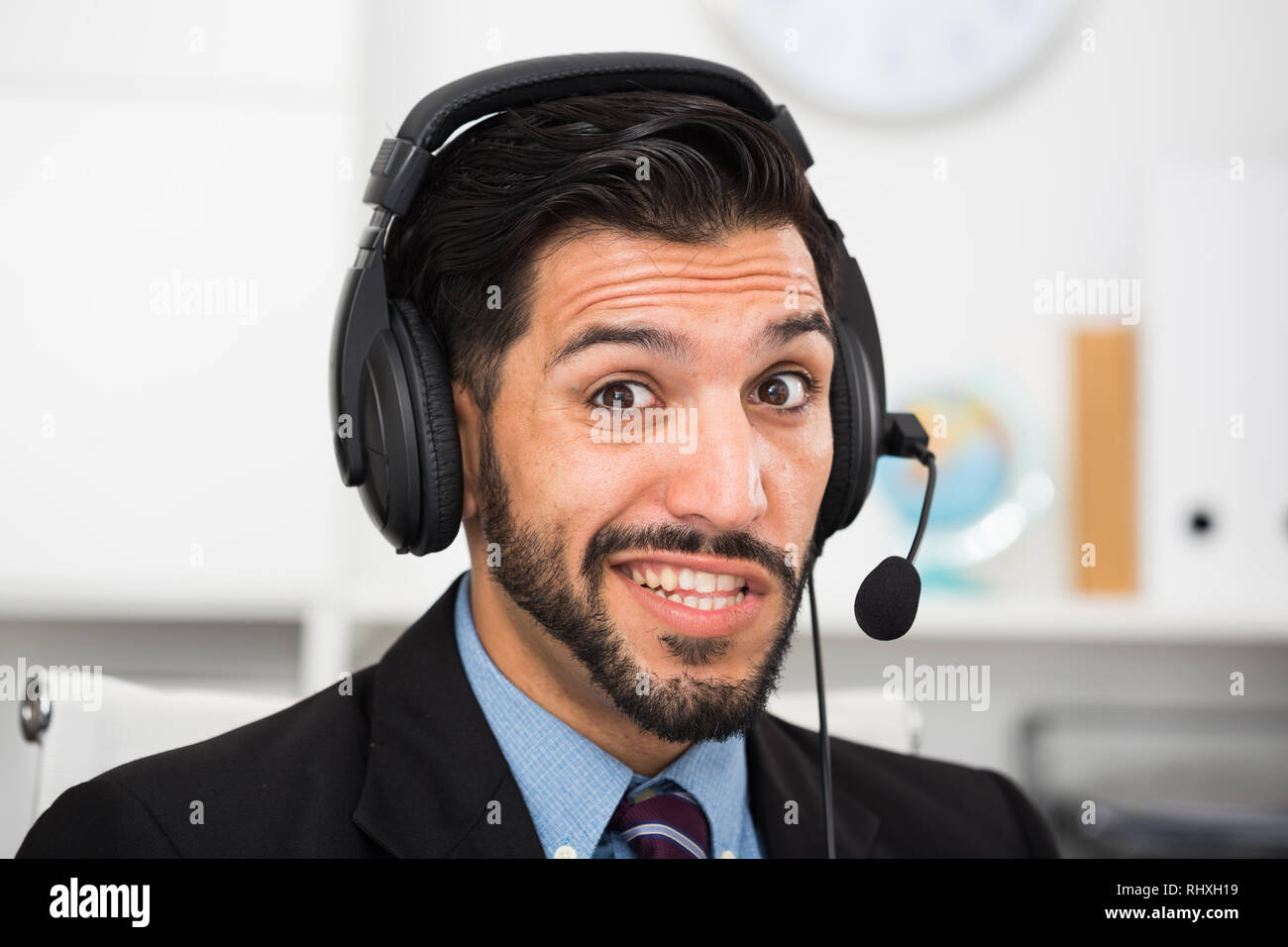 Portrait of spanish man dispatcher who is talking with client in office ...