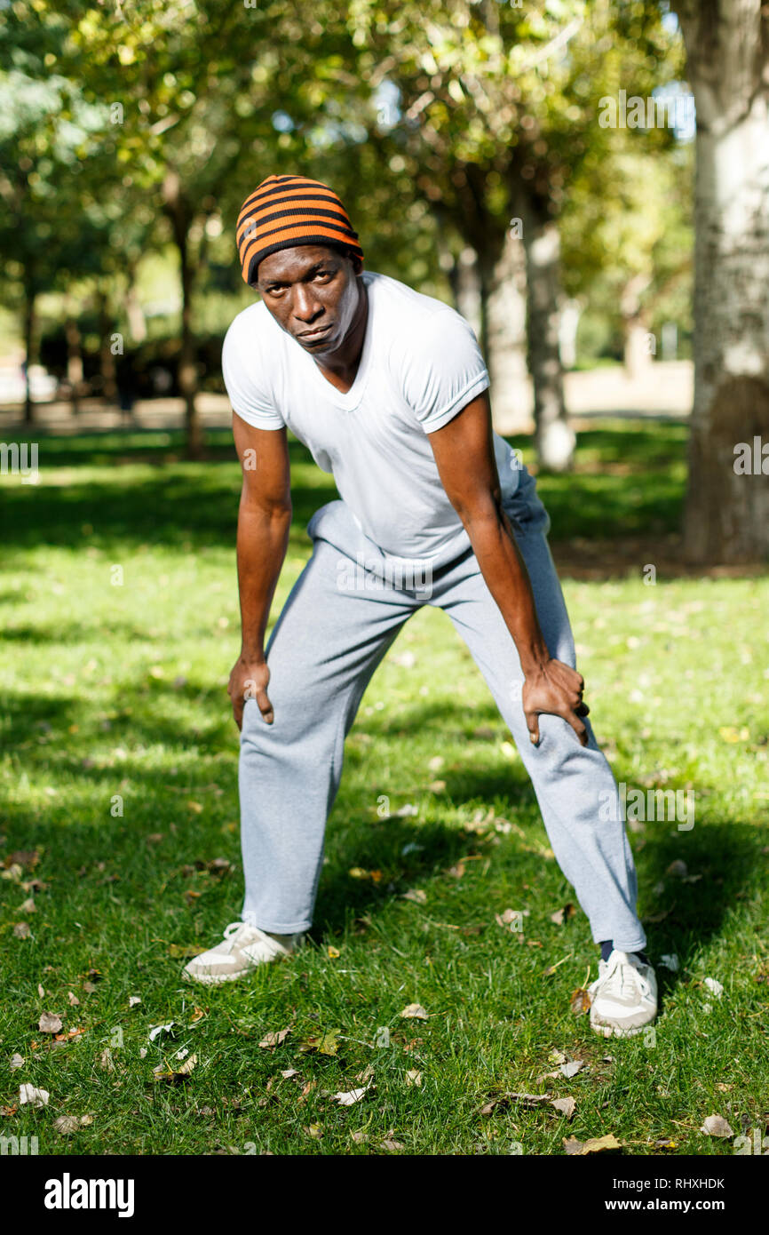 Portrait of active african american man doing exercises for legs ...