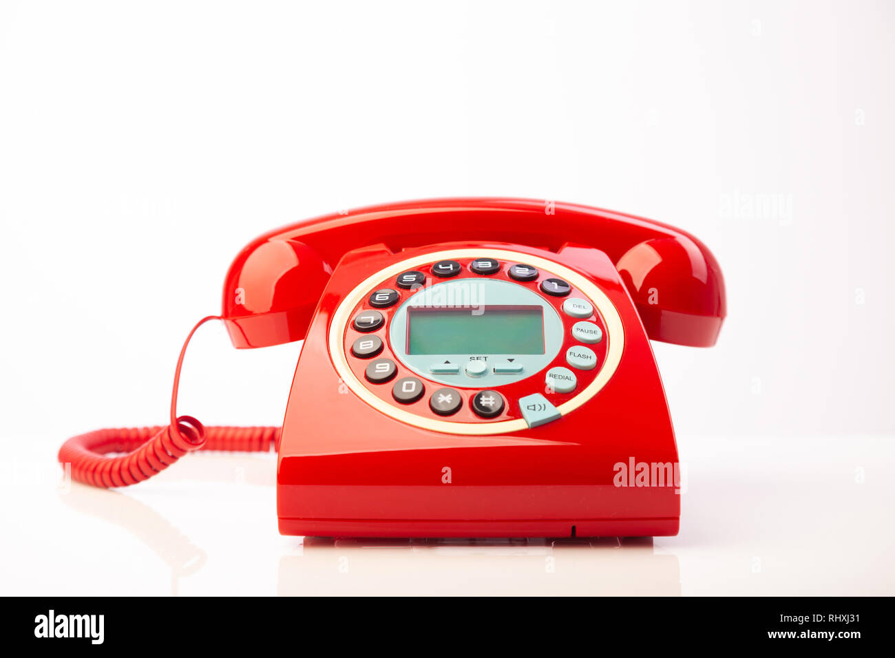 A red retro telephone from the front against a white background Stock ...