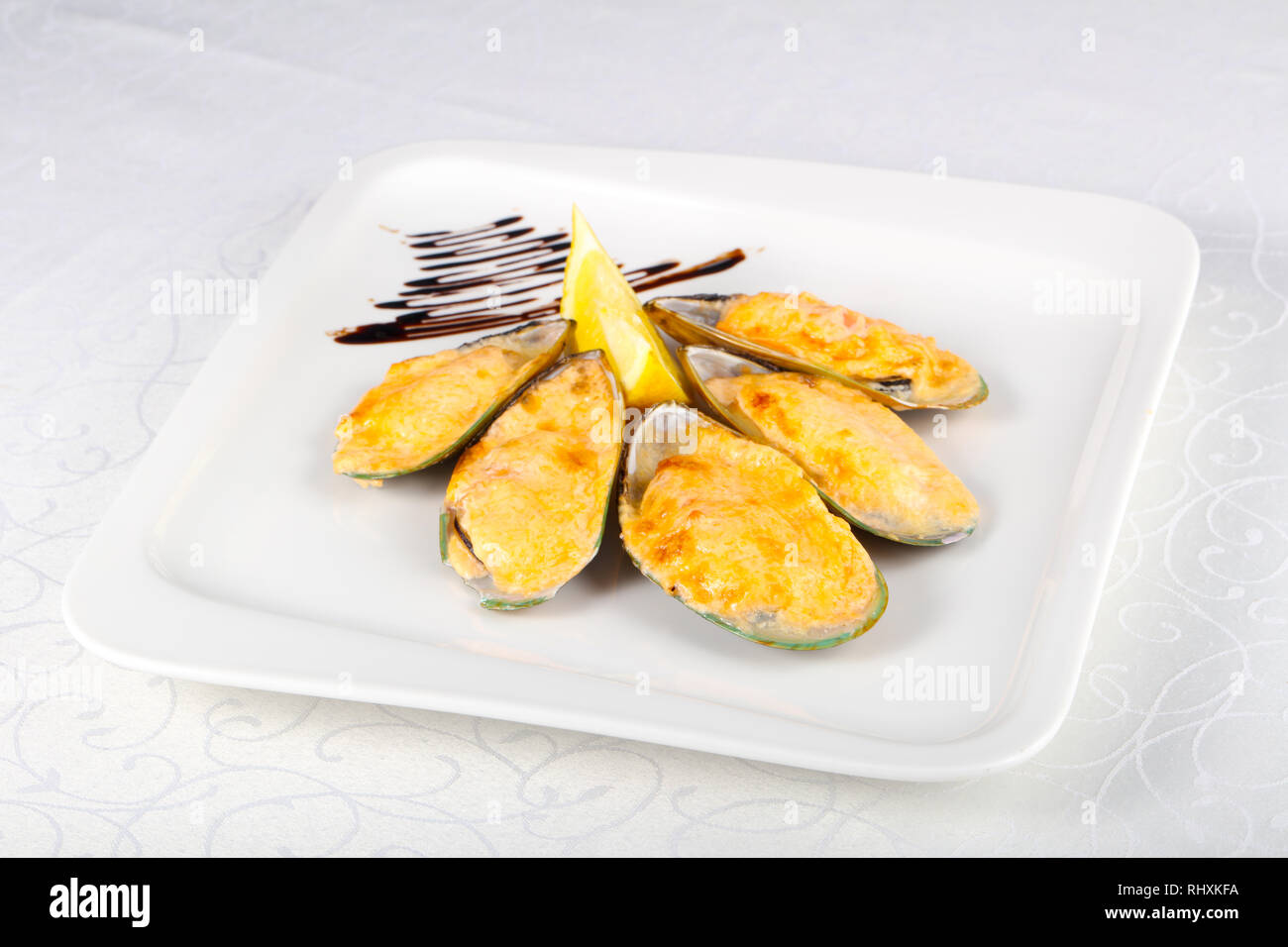 Baked mussels with cheese Stock Photo - Alamy