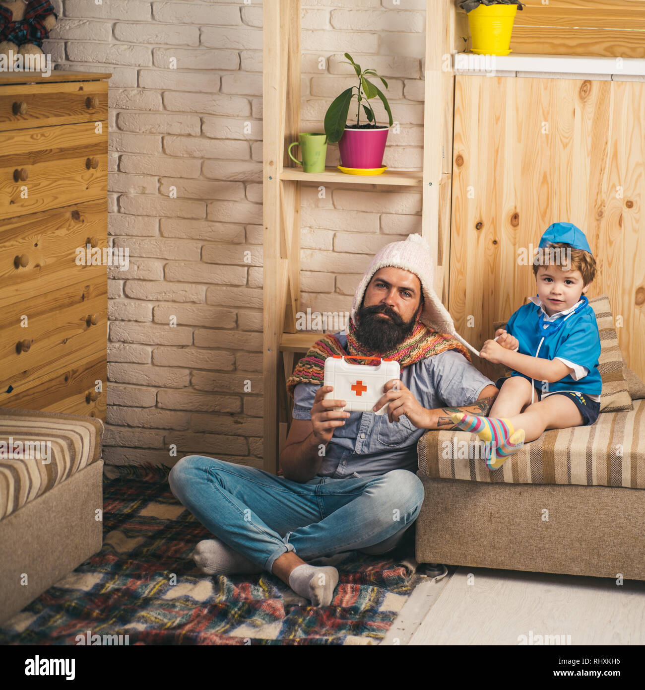 Father and kid playing together doctor and patient, medical theme ...