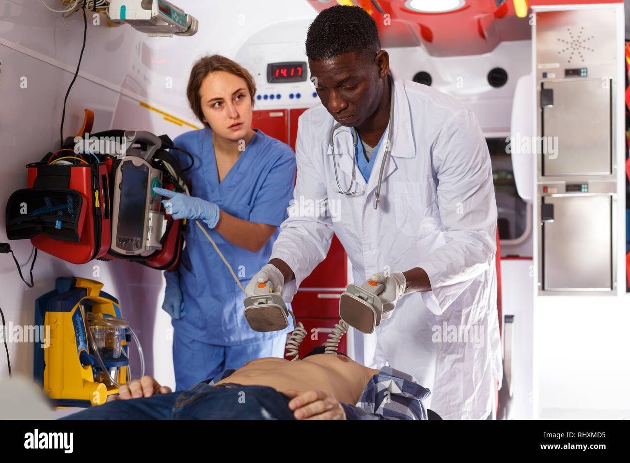 Doctor using defibrillator hi-res stock photography and images - Alamy