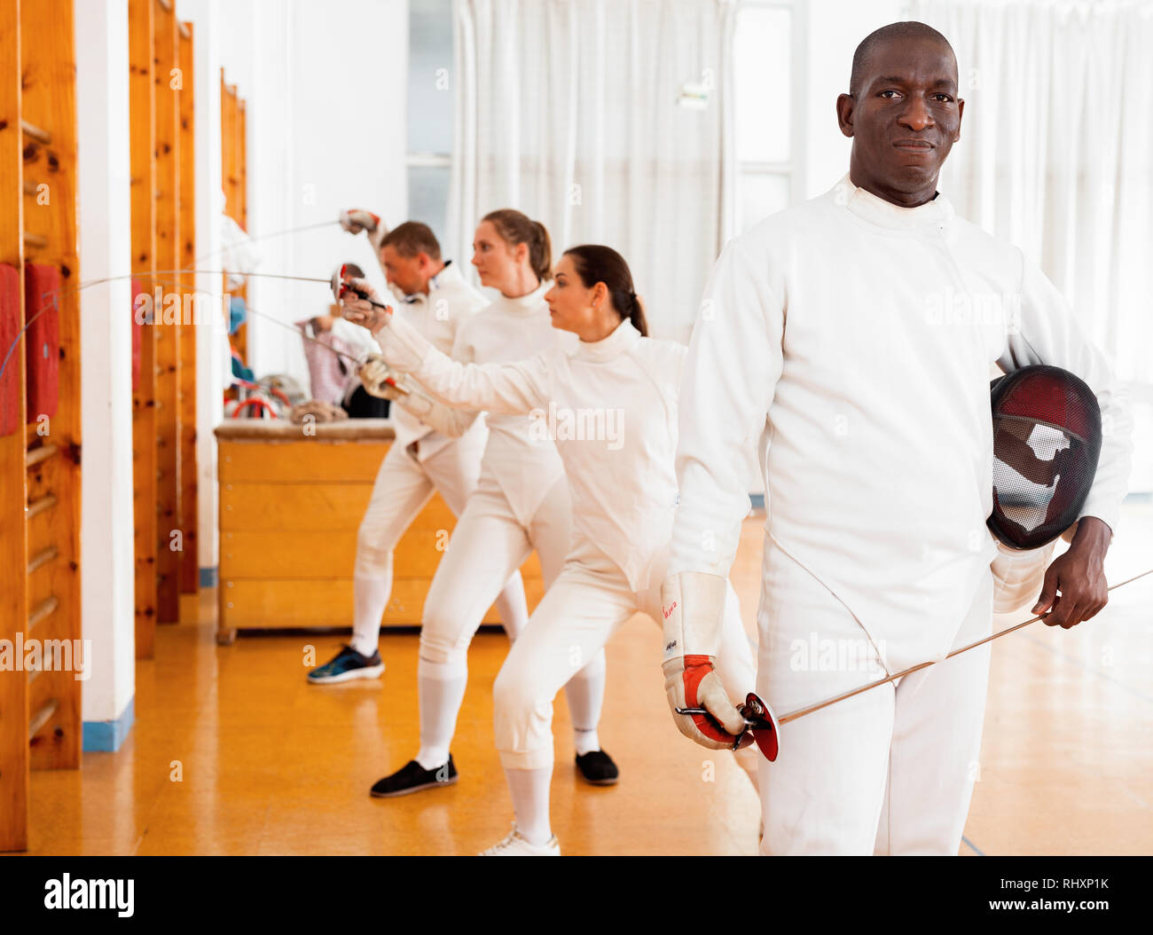 Active african american cheerful positive male fencer in uniform ...