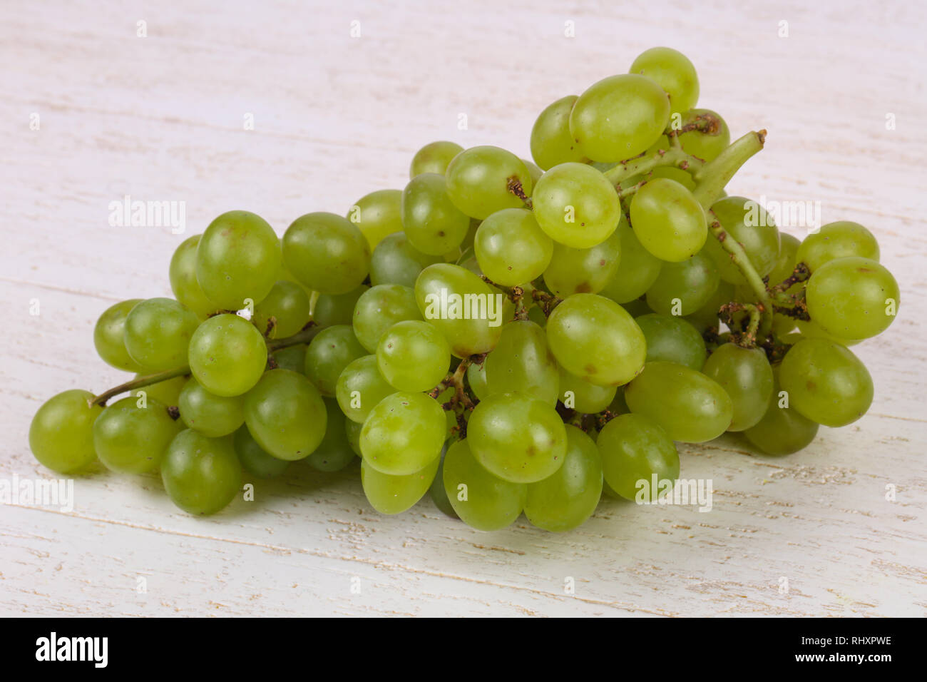 Sweet green grape branch over background Stock Photo - Alamy
