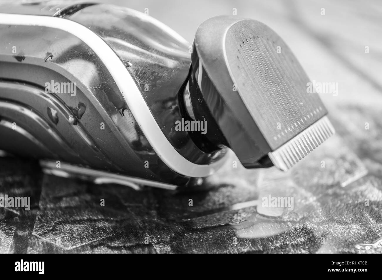 Close up of the blades of a man's electric shaving machine trimmer ...