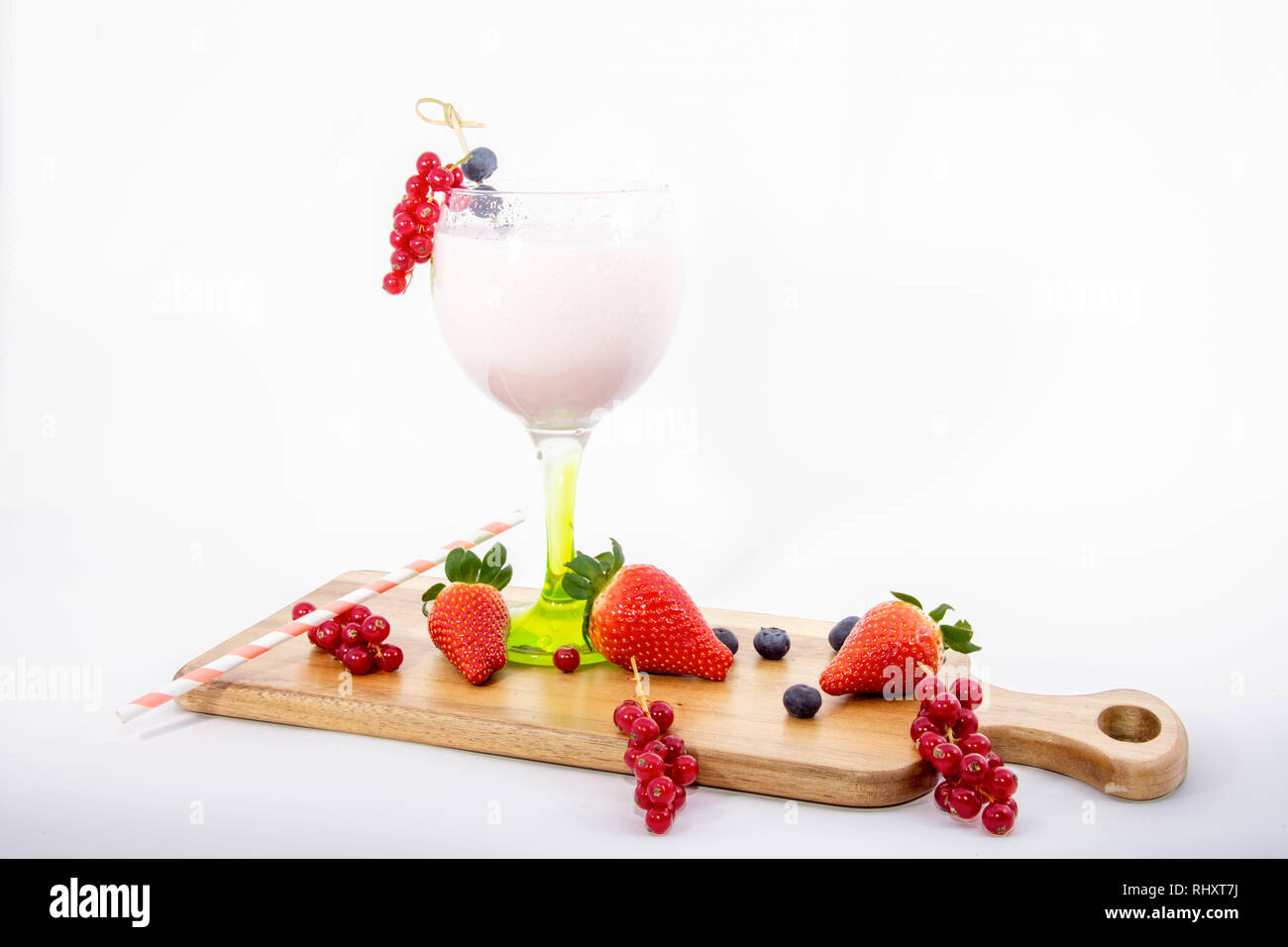 Strawberry milkshake in a glass of balloon with fruits Stock Photo - Alamy