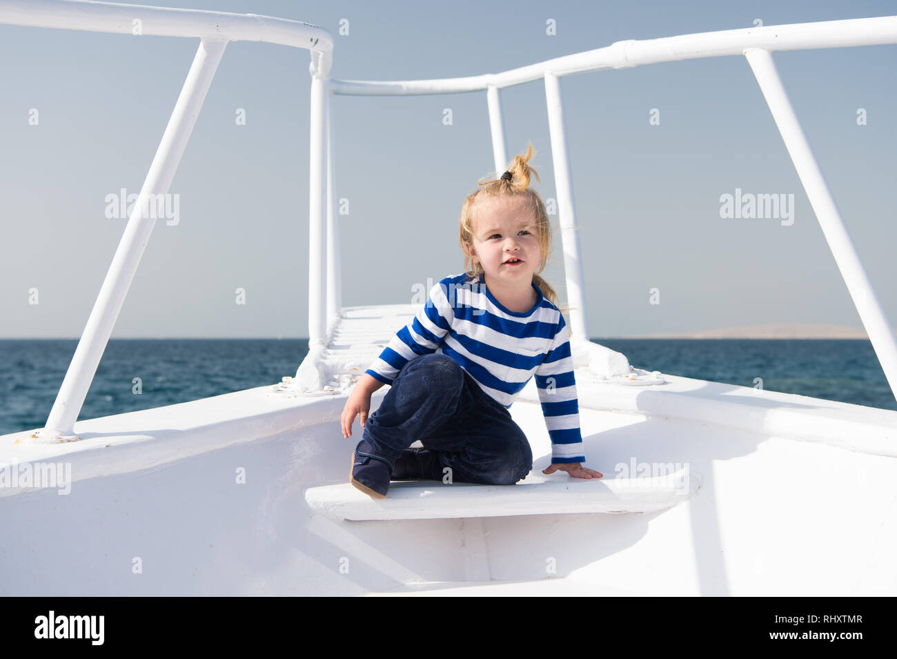 Childhood concept. Little child enjoy sea travel on ship, childhood ...