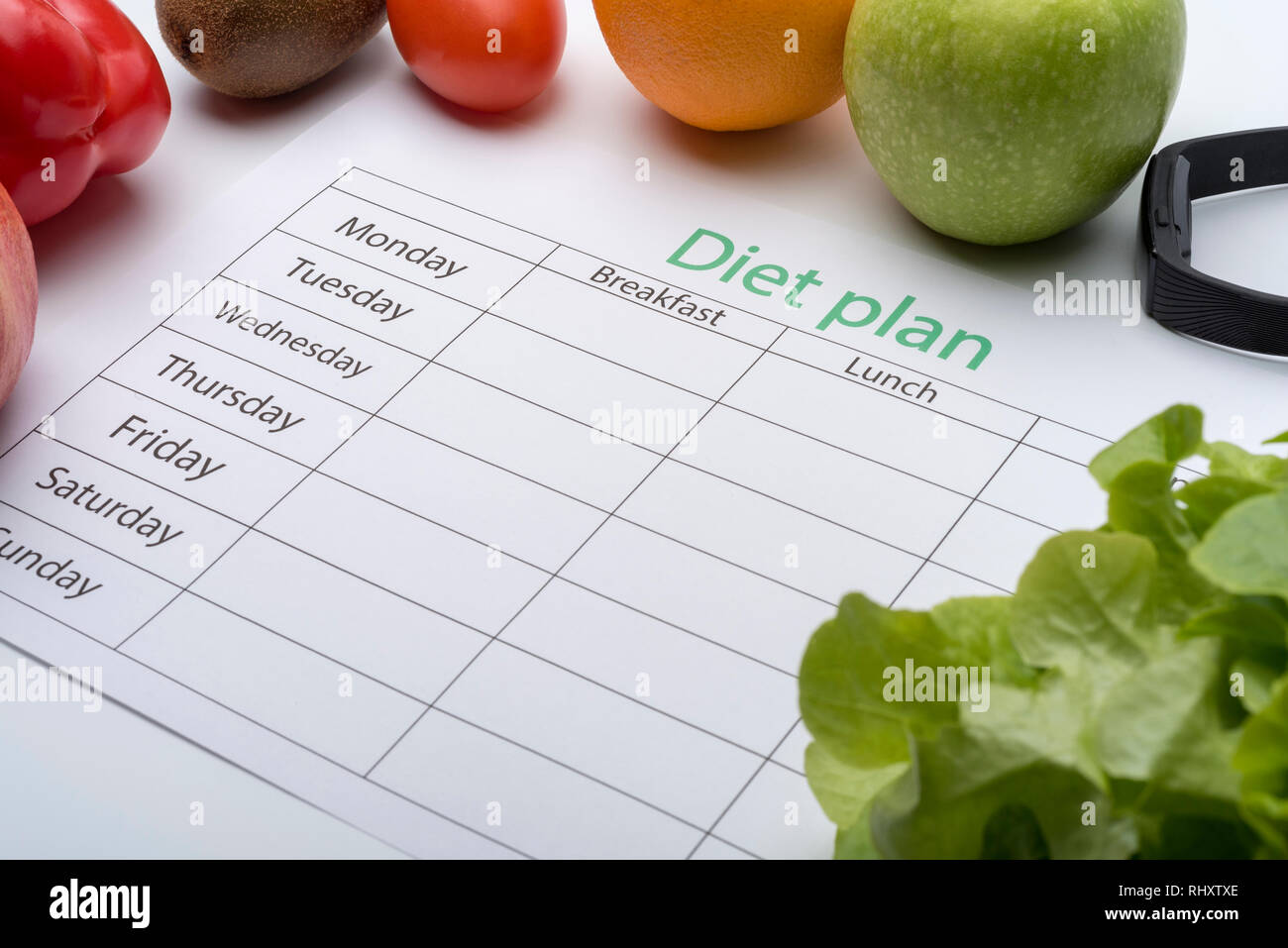 Diet plan sheet and fresh food on white background. Top view, the ...