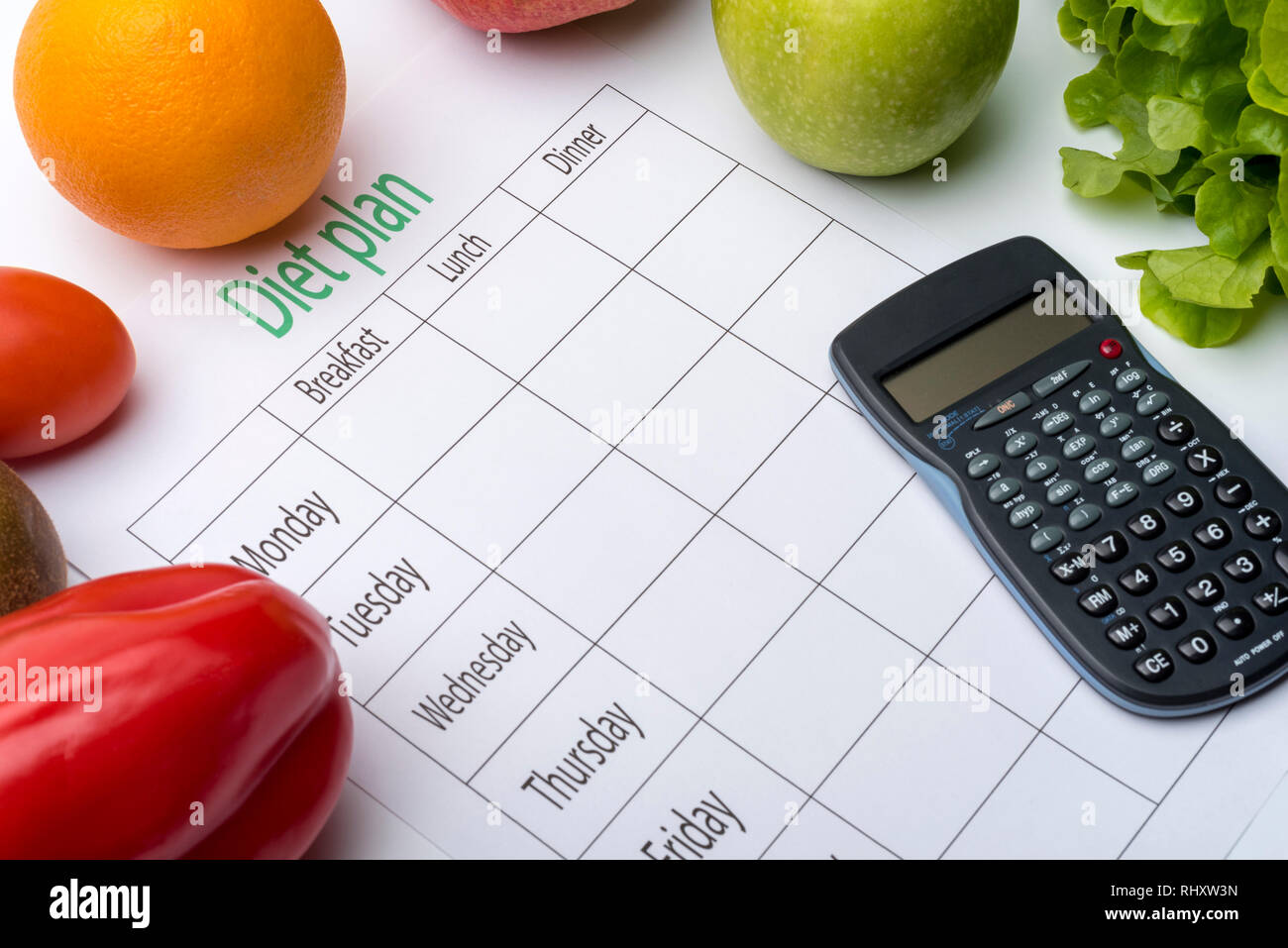 Diet plan sheet and fresh food on white background. Top view, the ...