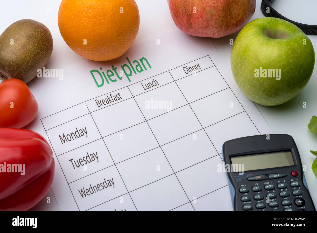 Diet plan sheet and fresh food on white background. Top view, the ...