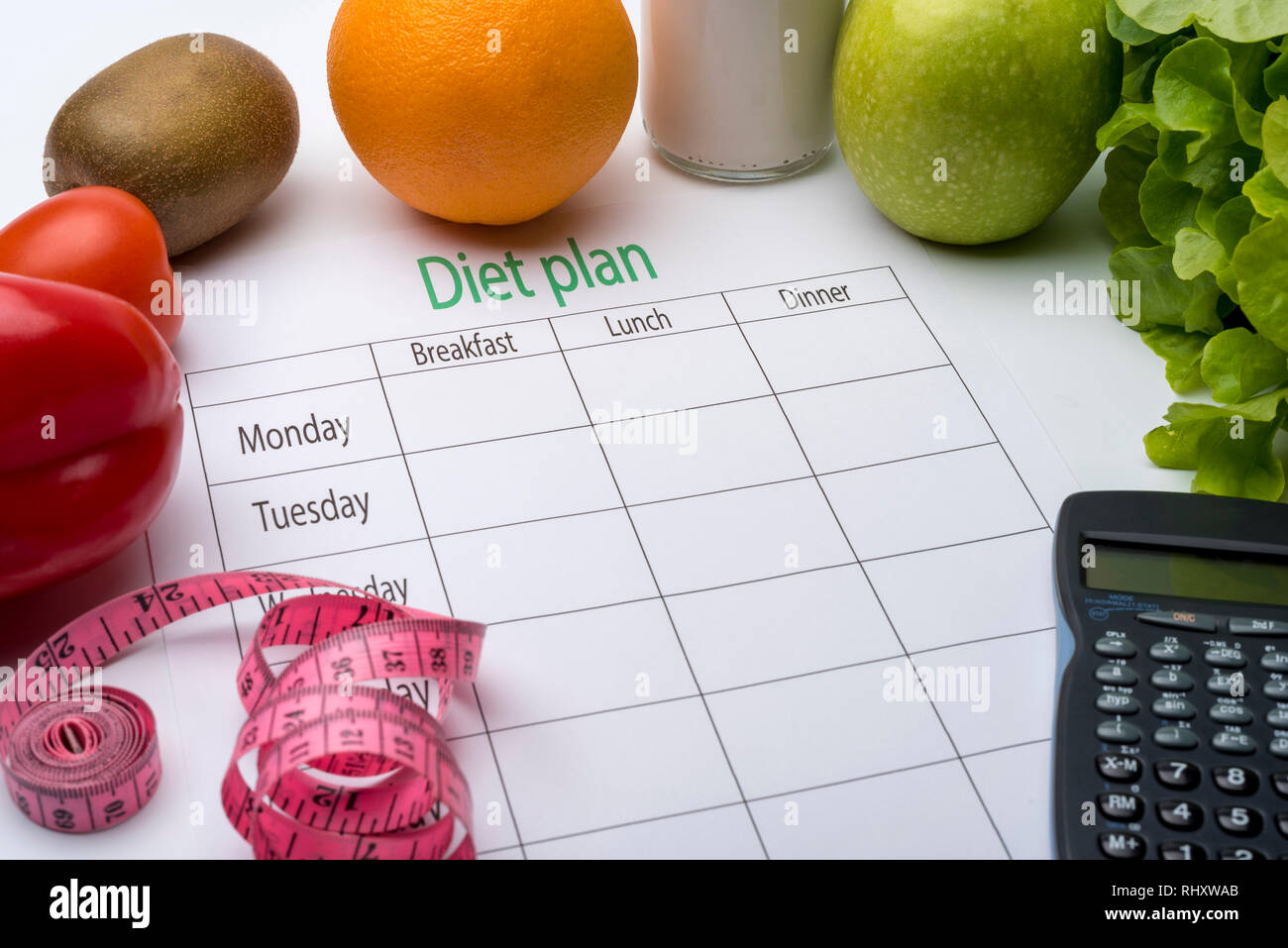 Diet plan sheet and fresh food on white background. Top view, the ...